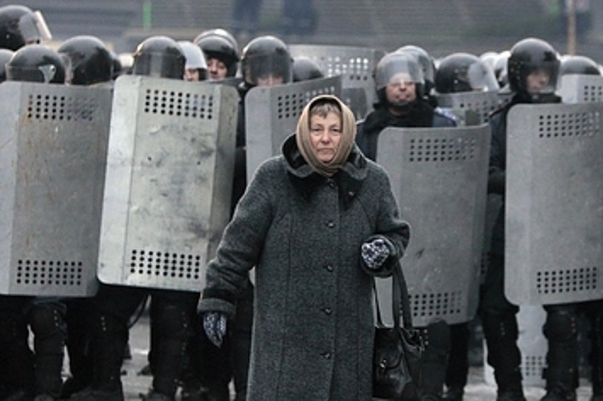 Incredibly Badass Photo Of An Old Woman Walking Through The Ukrainian Riots