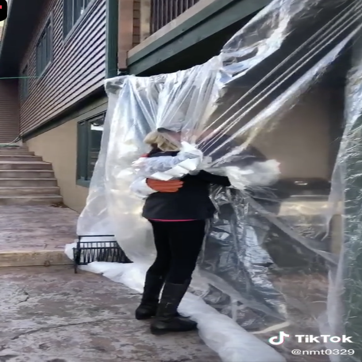 Family Creates Shield To Hug After Uncle's COVID Death