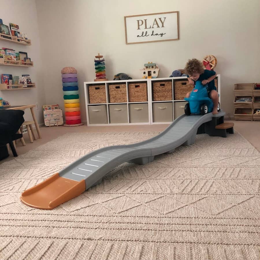 kid playing with toys on floor