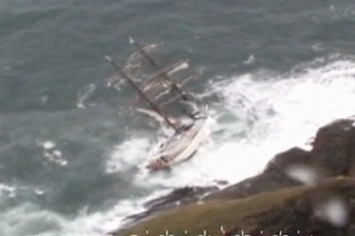 Sailing Ship Runs Up On The Rocks, Sinks