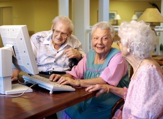 Old People Smiling While Using Computers