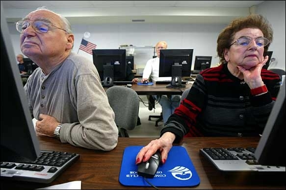 Old People Smiling While Using Computers
